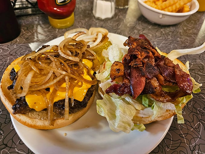 A tale of two burgers: One draped in melted cheese and grilled onions, the other loaded with bacon &ndash; both demanding to be devoured immediately.