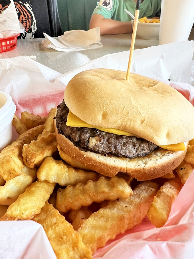 Behold the cheeseburger in its natural habitat&mdash;a thick, hand-formed patty nestled on a pillowy bun, surrounded by golden crinkle-cut sentinels.