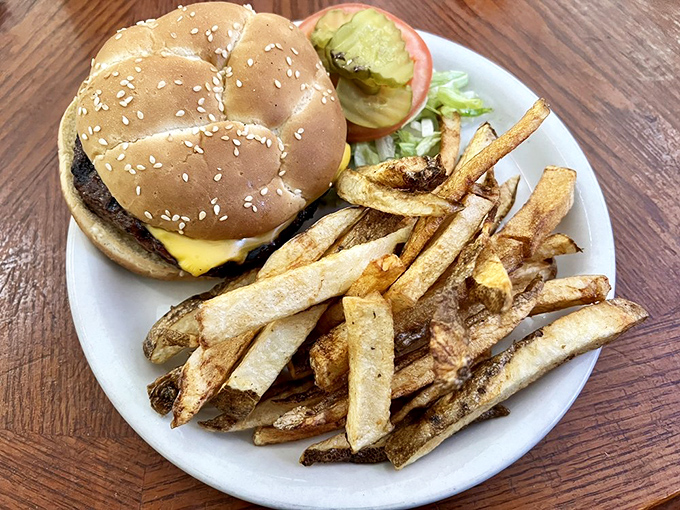 Behold the humble cheeseburger, elevated to art form. That sesame seed bun cradles beef perfection like it's holding the Hope Diamond.