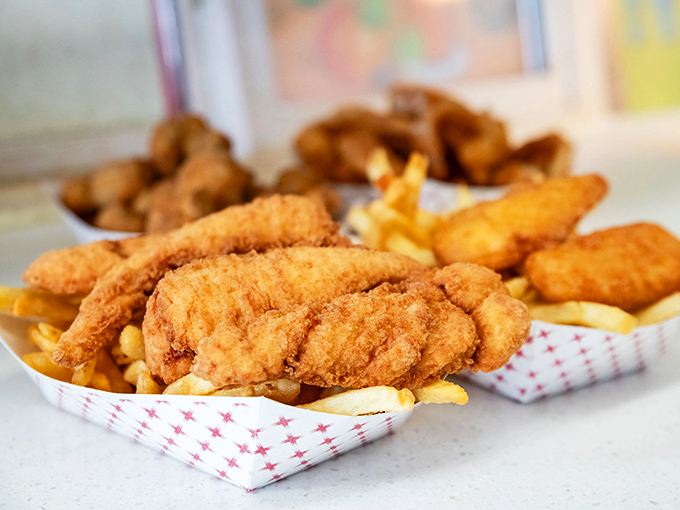 Golden-fried chicken tenders that could make the Colonel himself weep with envy, nestled alongside fries that demand to be noticed.