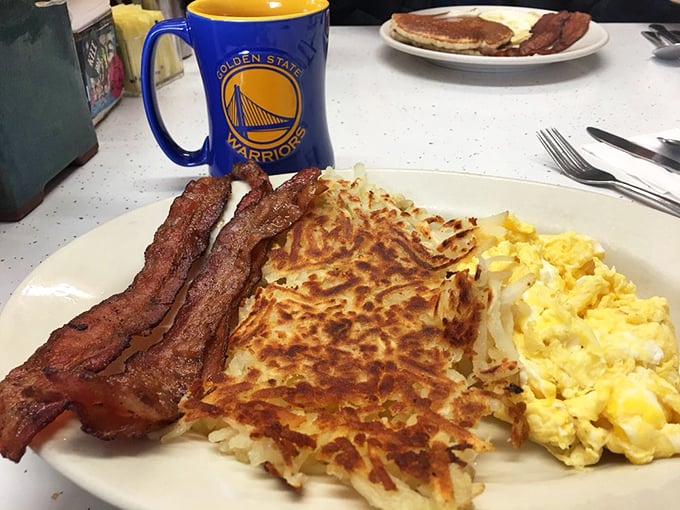 The breakfast platter that launched a thousand productive mornings. Those hash browns achieve the golden-brown perfection that home cooks dream about.