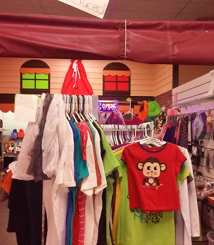 Colorful children's clothing hangs expectantly, including an adorable monkey shirt that's practically begging to go home with some lucky little one.