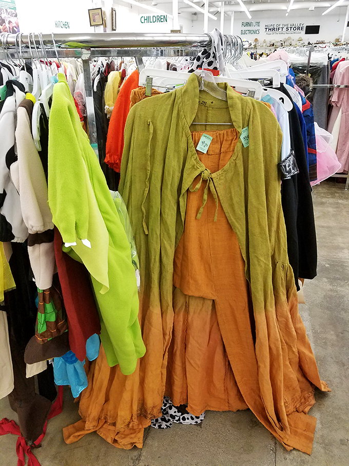 The children's section sits adjacent to clothing racks organized by color&mdash;a rainbow road of fashion possibilities spanning decades of style evolution.