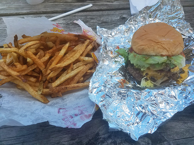 The holy trinity of roadside dining: golden fries with just the right crispness, a perfectly assembled burger, and the promise of a leisurely meal.