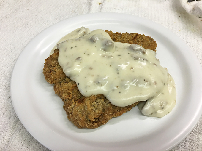 Country fried steak smothered in creamy sausage gravy&mdash;a dish so good it should require a permission slip from your doctor.