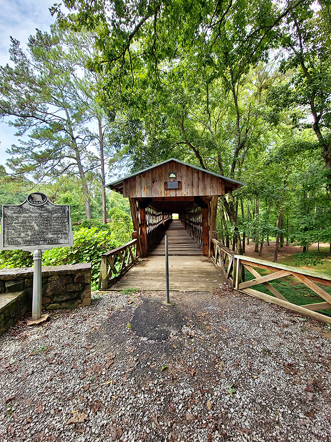 Summer's emerald canopy creates the perfect gateway to this historical treasure. The bridge doesn't just span a creek&mdash;it connects us to simpler times.