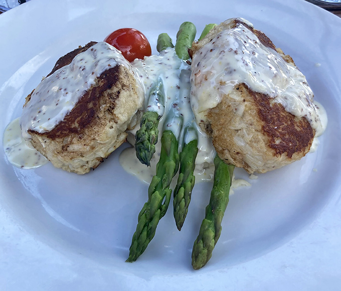Crab cakes that are all crab and no filler, served with asparagus so perfectly cooked it makes vegetables feel like the main event.