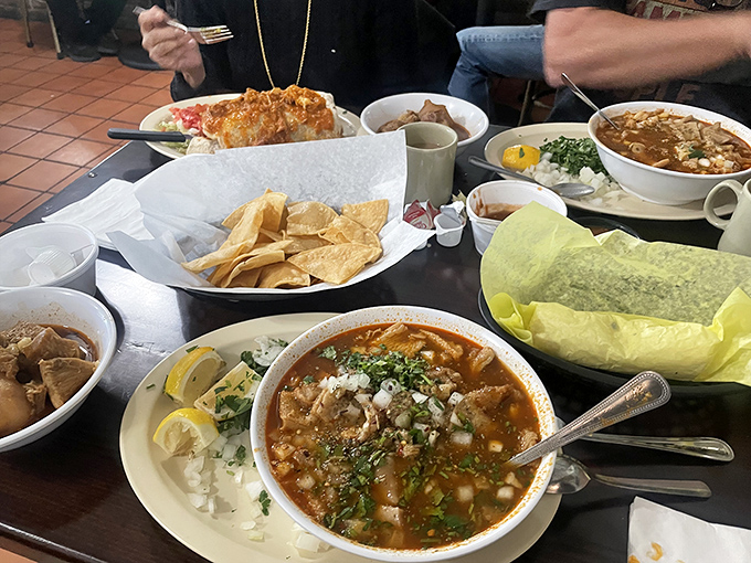 A feast fit for royalty spreads across the table, with menudo and chips standing by like loyal courtiers to the burrito monarchs.