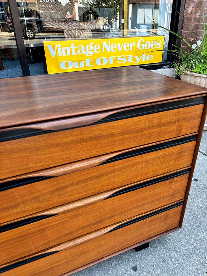 "Vintage Never Goes Out Of Style" proclaims the sign, while this impeccable dresser with wave-front drawers silently proves the point.