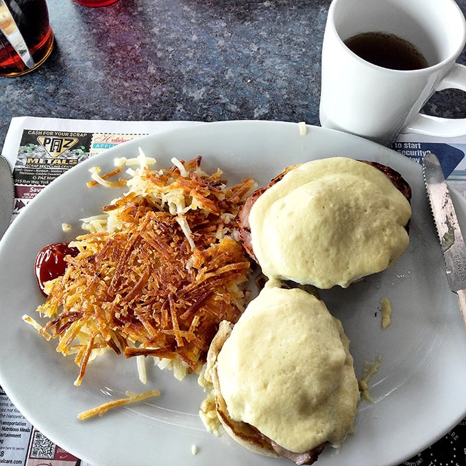 Eggs Benedict: where breakfast meets black tie. Two perfectly poached eggs perched atop Canadian bacon and English muffins, draped in hollandaise like they're heading to the Oscars.