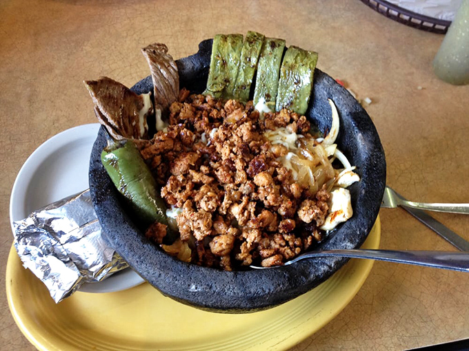El molcajete arrives like a volcanic eruption of flavor&mdash;the traditional stone bowl keeping everything sizzling hot while you contemplate where to dive in first.