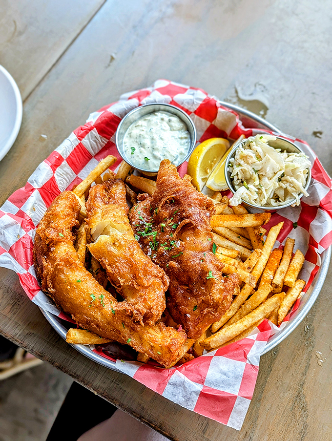 Golden-battered fish that shatters with each bite, served with fries so perfectly crisp they deserve their own fan club.
