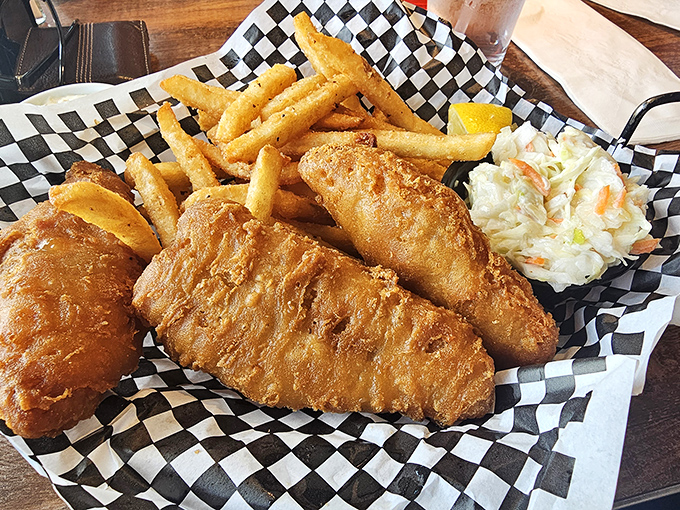 Fish and chips that would make a British pub jealous, served with a side of coleslaw that actually deserves to be eaten.