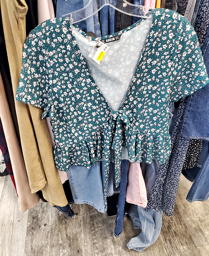 That floral top whispers "summer romance" while the price tag screams "budget victory." Fashion poetry in green and white.