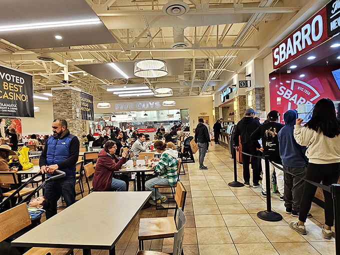 The bustling food court offers a welcome respite for weary shoppers. Nothing says "I deserve this" like Five Guys after conquering the Kate Spade sale.