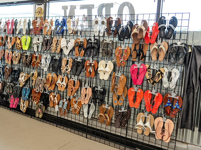 Flip-flops and sandals hang like colorful fruit, a footwear orchard where last season's styles await their chance to hit the beach again. 