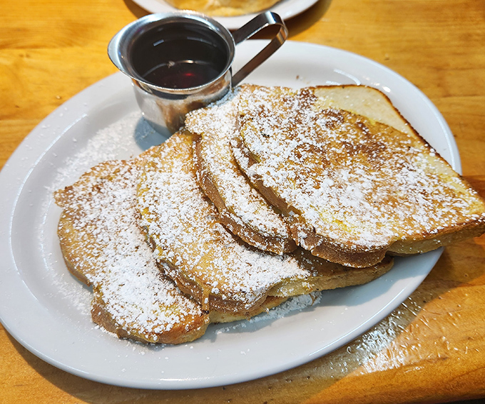 French toast that's dressed for success with a powdered sugar snowfall. Maple syrup in that silver pitcher is liquid gold.