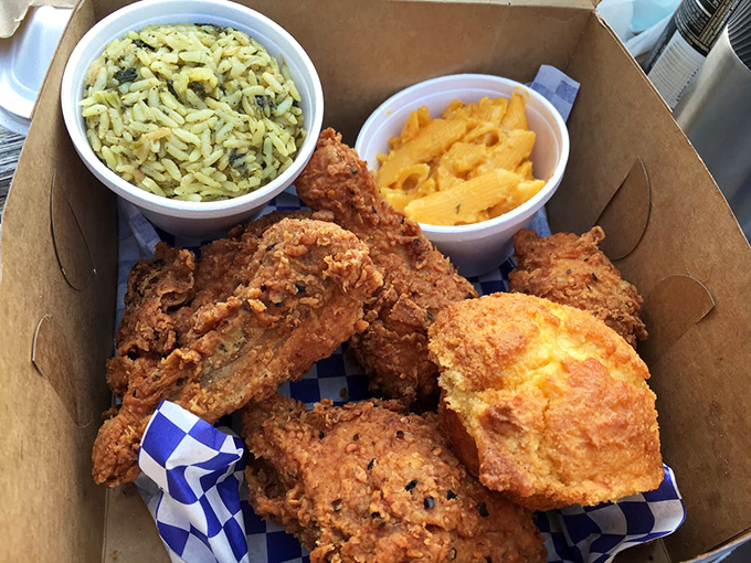 A cardboard treasure chest filled with crispy, auburn jewels. The herb-flecked rice and electric-orange mac and cheese make perfect courtiers.