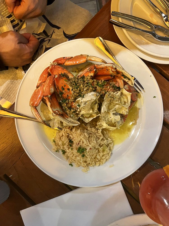 Dungeness crab gets the royal treatment with garlic butter, herbs, and a side of perfectly cooked rice.