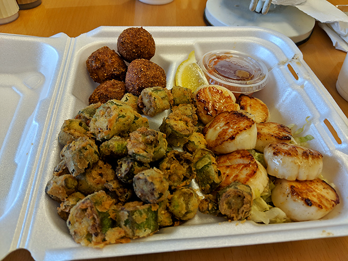 A holy trinity of seafood perfection: perfectly seared scallops, crispy hushpuppies, and fried okra that could convert even the most stubborn okra skeptic.