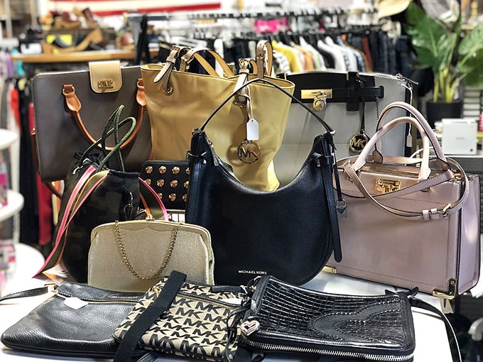 Designer handbags stand at attention like leather-bound soldiers, each one carrying the ghost of shopping sprees and special occasions past.