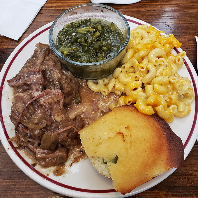 Southern comfort on a plate &ndash; tender meat, collard greens swimming in pot likker, and mac and cheese that demands your full attention.