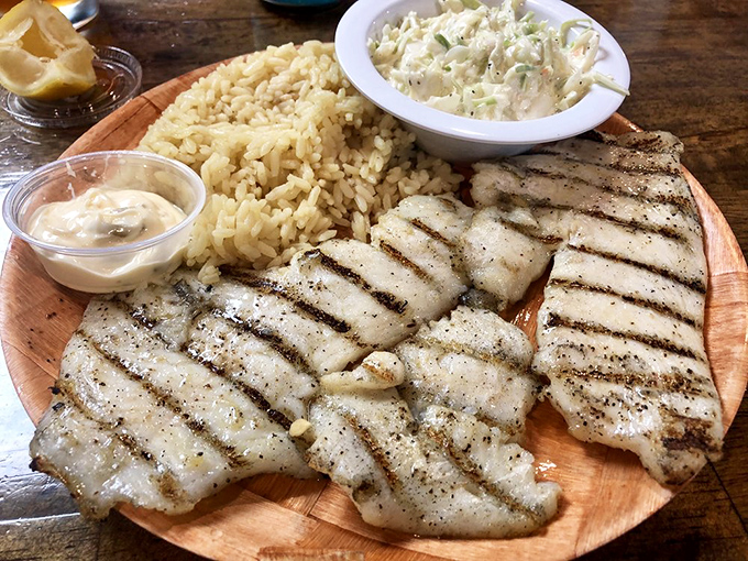Grilled fish so perfectly done it practically whispers "Florida" with each flaky, tender bite. The rice and slaw aren't mere sides—they're worthy companions.
