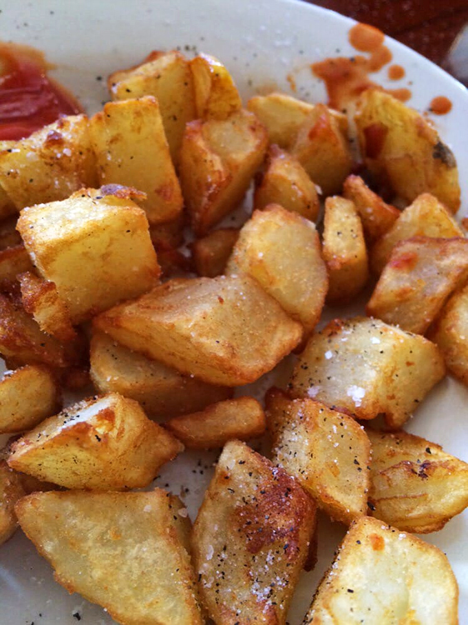 The legendary home fries &ndash; golden potato cubes with crispy edges and tender centers that could make a grown Floridian weep with joy.
