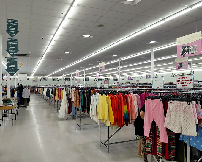 The women's clothing section stretches toward retail infinity. Color-coded racks make finding that perfect blouse less like hunting and more like shopping.