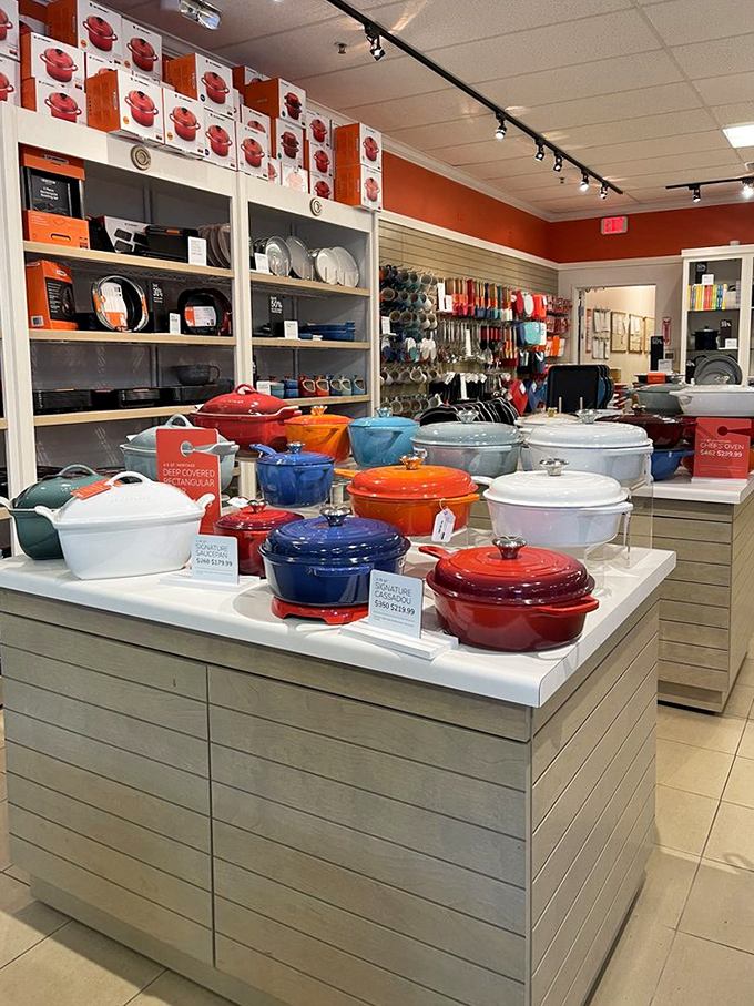 Le Creuset's Dutch ovens gather like colorful culinary jewels, each one promising decades of perfect braises and family recipe magic.