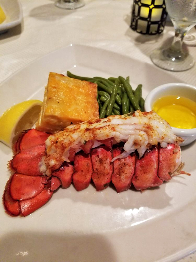 This lobster tail isn't just dinner—it's a crustacean celebration, split and grilled to perfection, waiting for its butter bath.
