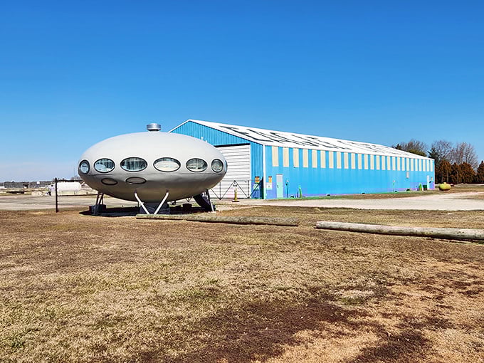 Nestled against a bright blue hangar, the Futuro House looks like the punchline to a joke about what happens when architects dream.