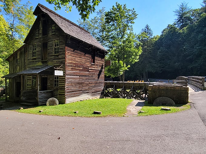 The Grist Mill in summer light reveals its meticulous craftsmanship, a testament to when buildings weren't just constructed but lovingly created.