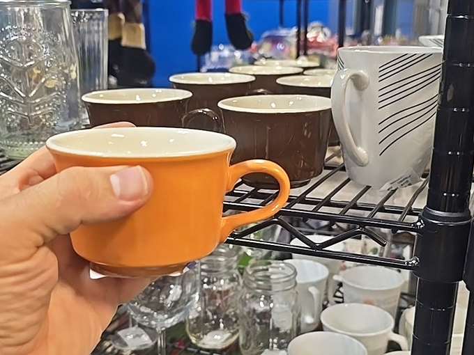 This orange mug could tell stories of morning coffees past, now waiting patiently for its next caffeine-fueled adventure.