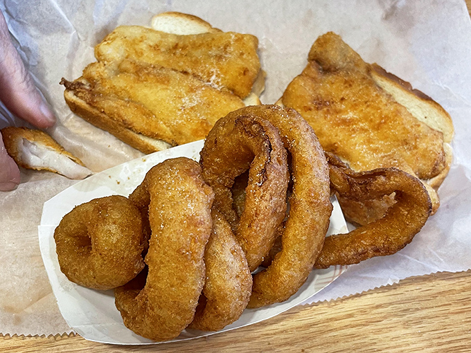 Golden onion rings and the famous fish sandwich - a combo that's converted more non-believers than Sunday morning television. Crispy, comforting perfection.