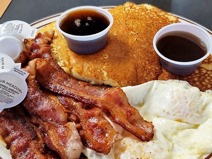 The holy trinity of breakfast perfection: golden pancakes, eggs with just-right yolks, and bacon that's somehow both crisp and tender. This is why morning people exist.