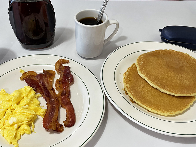 The breakfast trinity&mdash;golden pancakes, perfectly scrambled eggs, and bacon that's achieved that mythical balance between crisp and chewy.