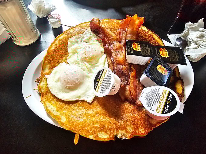 Pancakes that stretch to the edge of the plate, eggs with perfect sunny centers, and bacon that's achieved that magical balance of crisp and chew.