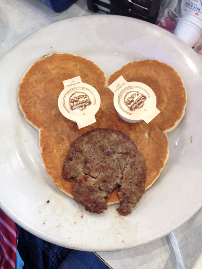 Mickey Mouse pancakes with sausage&mdash;childhood joy served on a plate that makes adults smile just as wide.