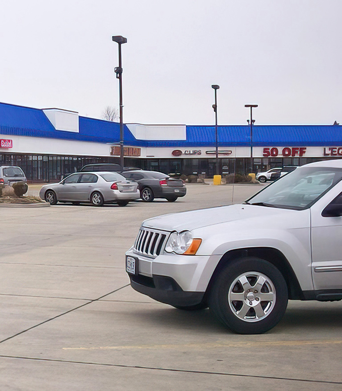 Cars gather like moths to a flame, drawn by the irresistible promise of retail therapy.