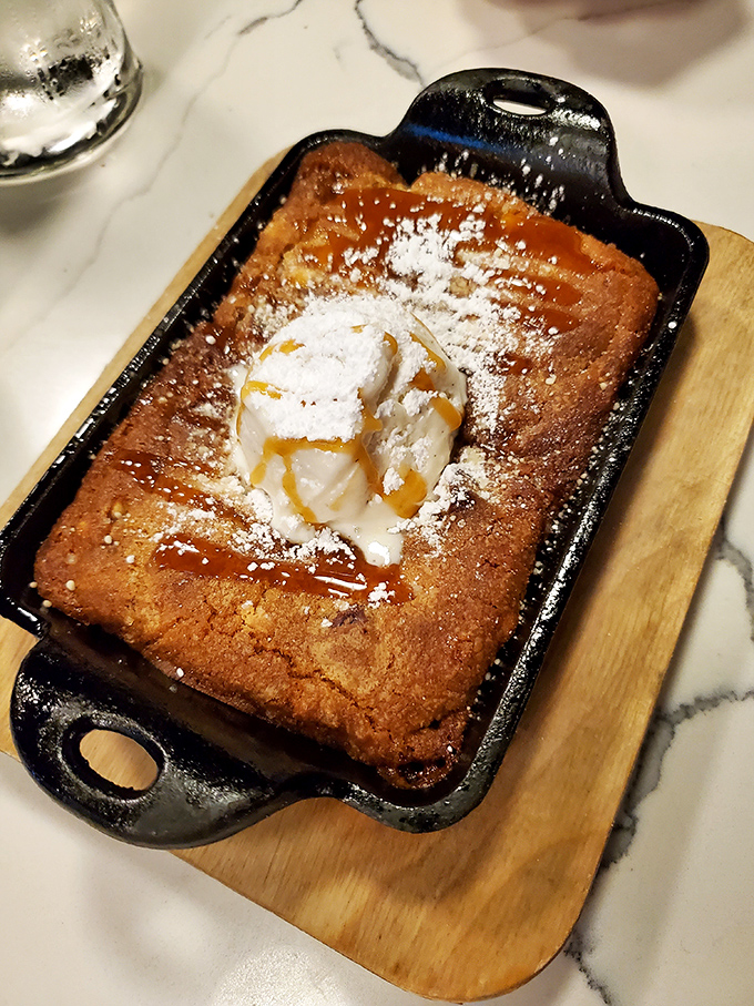 Warm peach cobbler in a cast iron skillet&mdash;proof that dessert can simultaneously be rustic, elegant, and worth every single calorie.