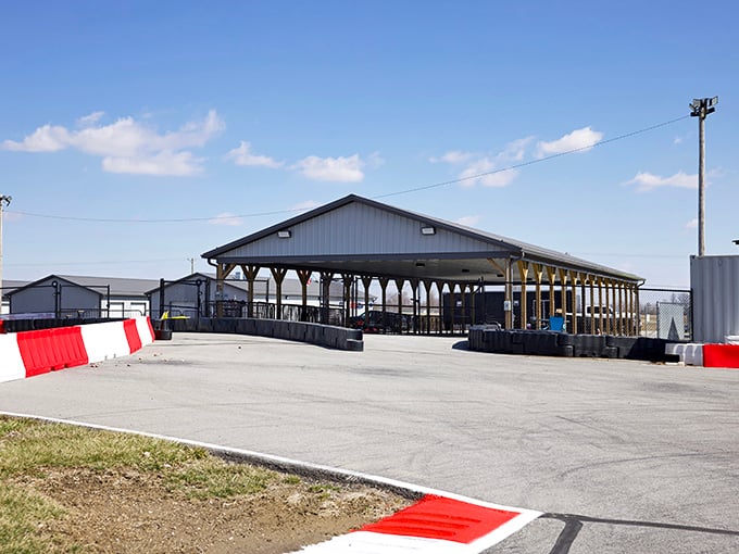 The covered pit area offers shade for mechanics and drivers alike. Racing strategy happens here, usually involving phrases like "floor it!"