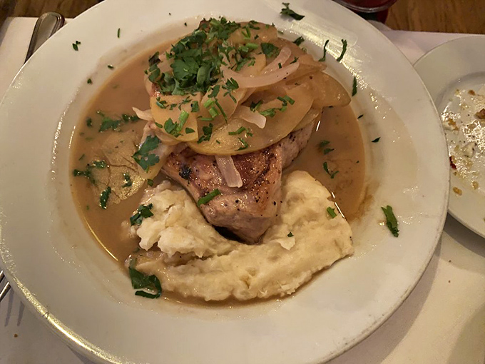 This pork chop doesn't just sit on mashed potatoes&mdash;it reigns over them, crowned with caramelized onions in a sauce worth sipping like fine wine.