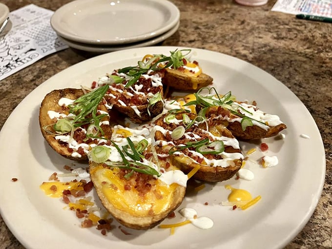 Loaded potato skins that actually deliver on "loaded." That perfect ratio of crispy skin to melty cheese makes sharing these a true test of friendship.