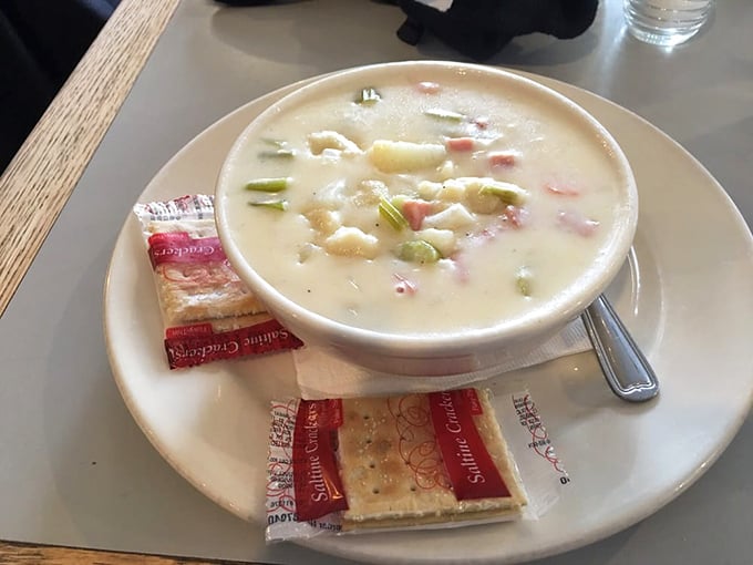Potato soup that looks like it's been practicing the art of creaminess for decades, with crackers waiting patiently for their supporting role.