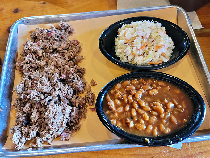 Pulled pork that maintains its dignity – tender enough to surrender to your fork but still structured enough to remind you it once had purpose.