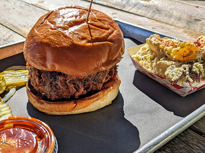 This isn't just a sandwich; it's an architectural marvel of smoked meat engineering, with potato salad playing a crucial supporting role.