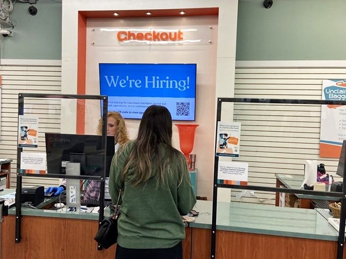 Even the checkout area maintains the store's cheerful orange branding. The final stop on your journey through other people's forgotten treasures.