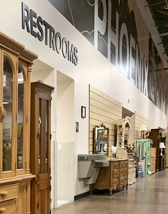 Elegant wooden cabinets stand sentinel near the restrooms, offering both bathroom directions and furniture inspiration in one glance.