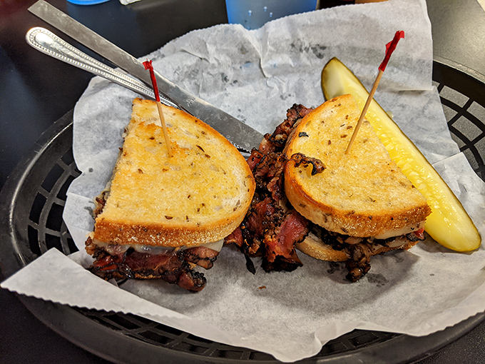 The Reuben arrives like a grilled masterpiece, its layers of flavor stacked with the precision of a Jenga champion.